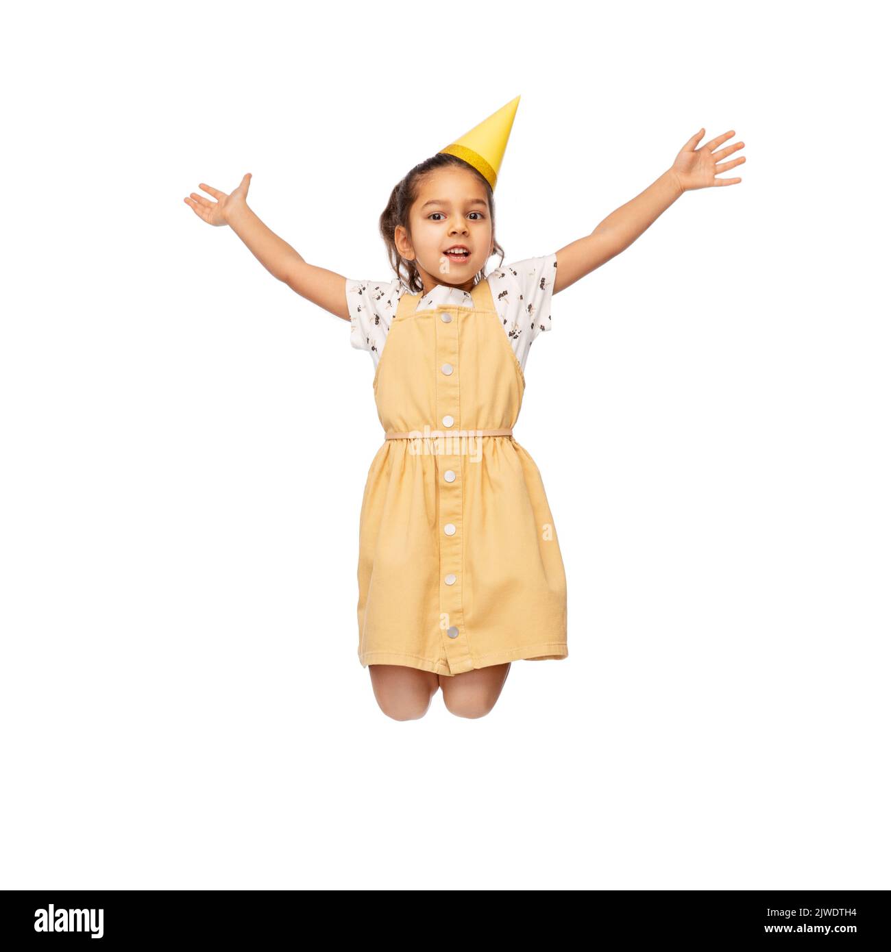 smiling little girl in birthday party hat jumping Stock Photo - Alamy