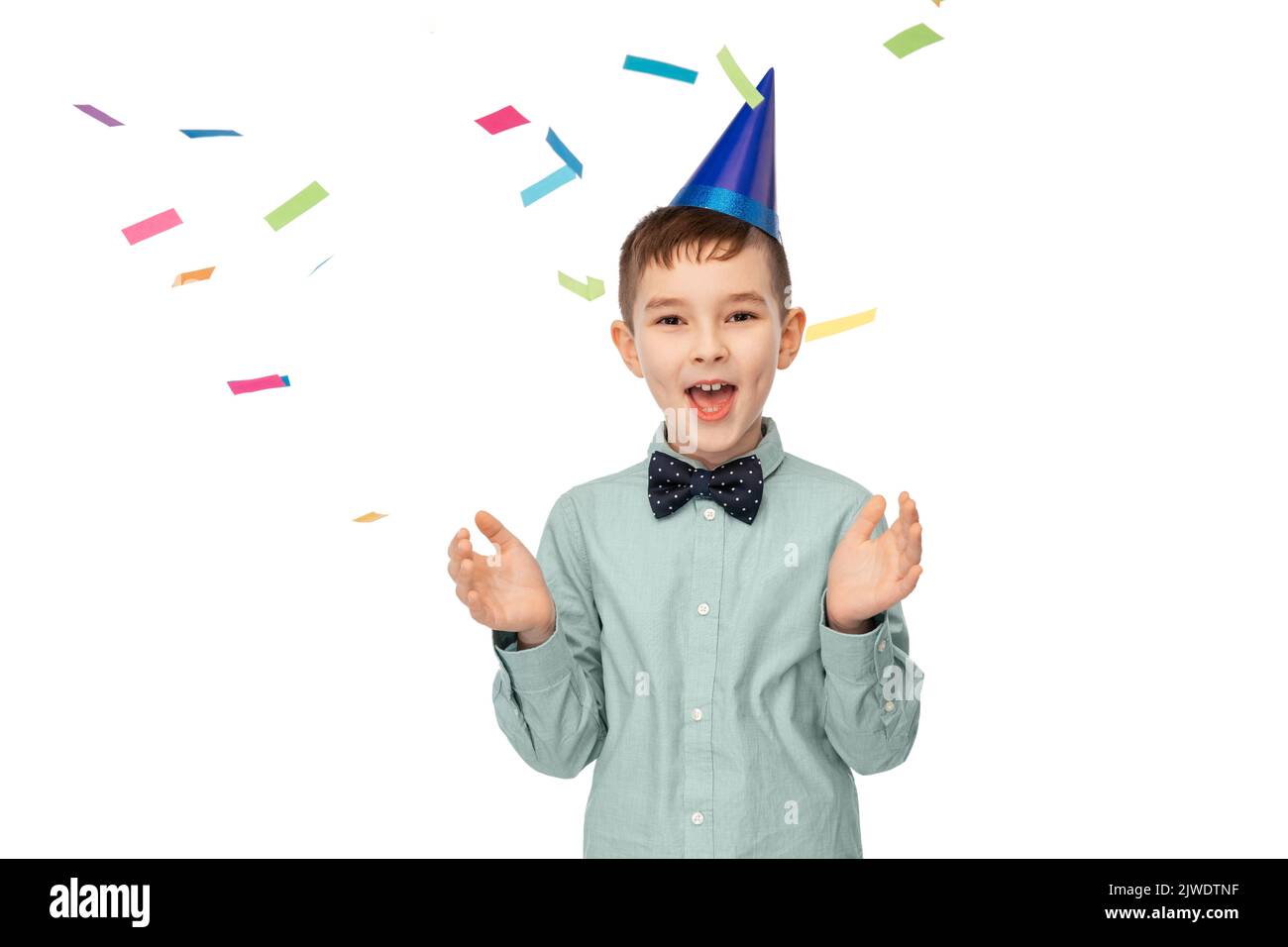 smiling boy in birthday party hat clapping hands Stock Photo - Alamy