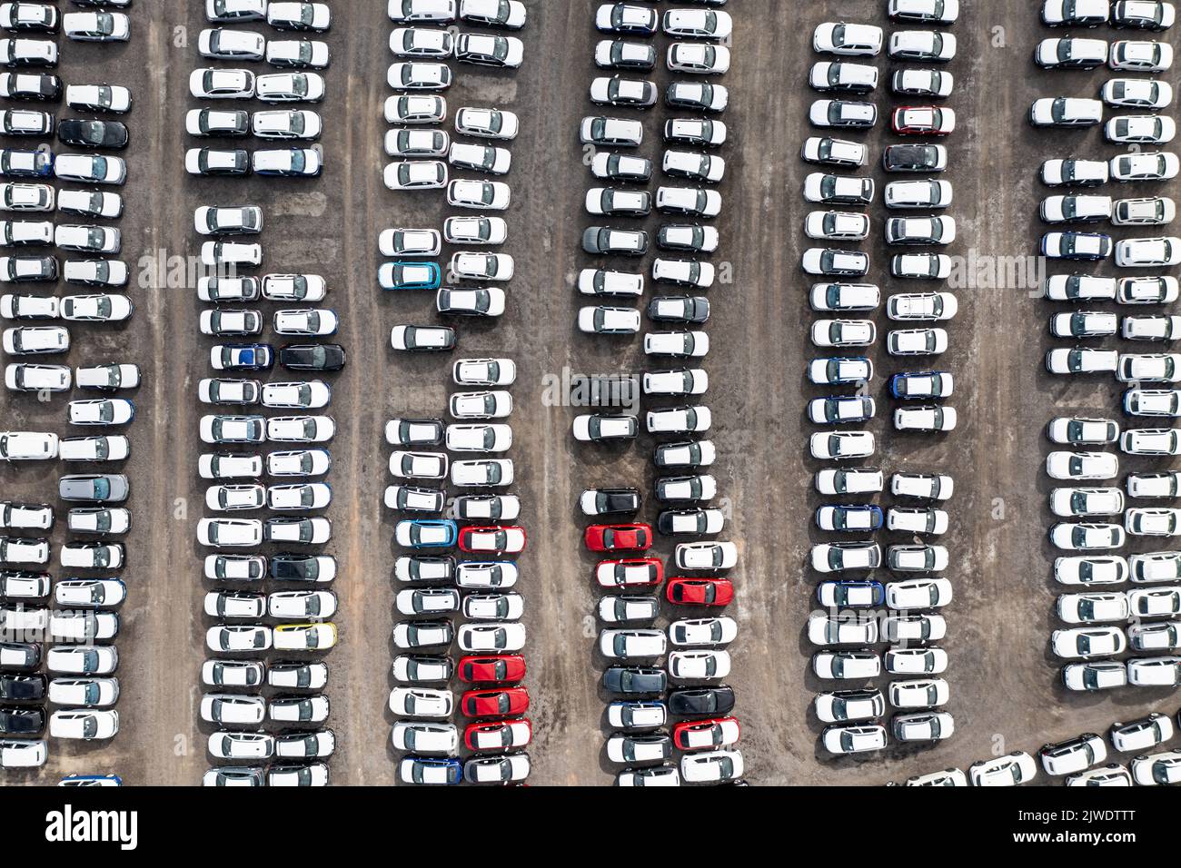 An aerial view of rows of newly built cars and vehicles ready for ...