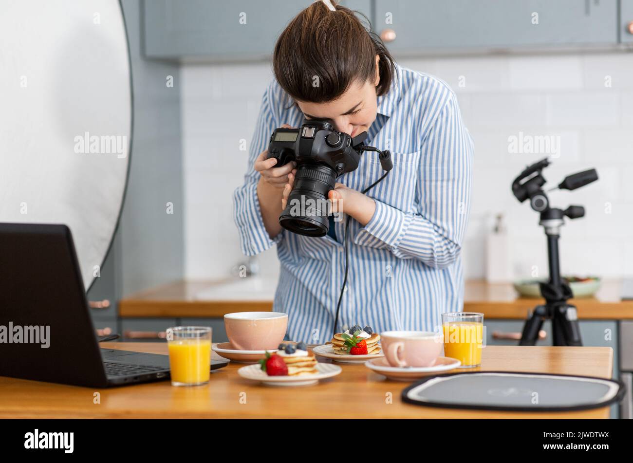 food photographer with camera working in kitchen Stock Photo - Alamy
