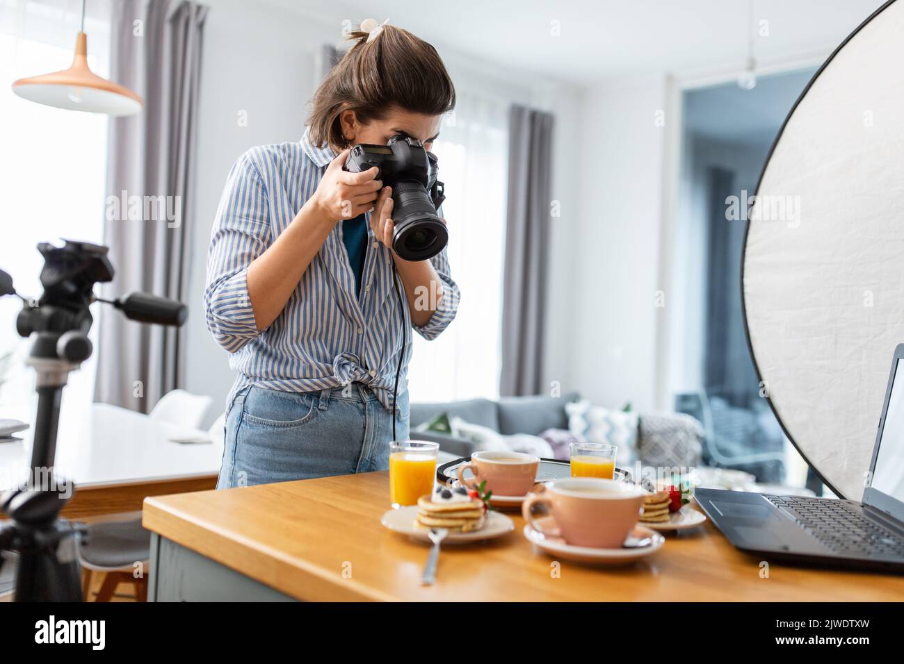 food photographer with camera working in kitchen Stock Photo - Alamy