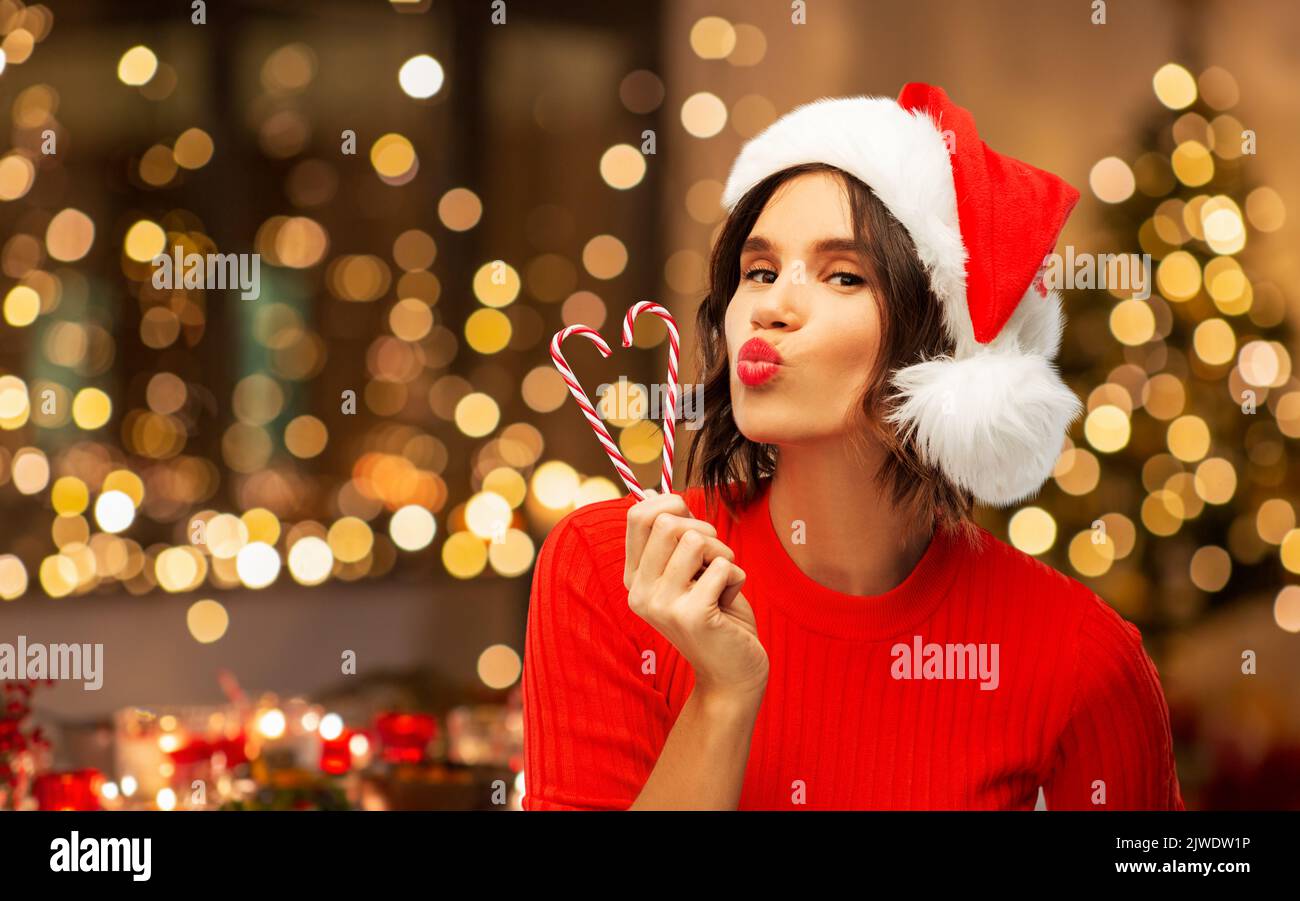 pretty woman with candy canes on christmas Stock Photo - Alamy