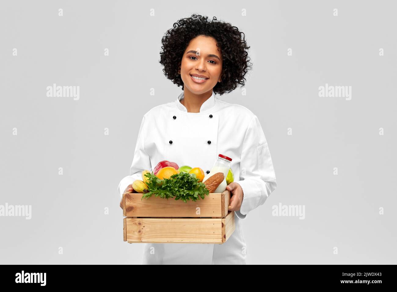 happy smiling female chef with food in wooden box Stock Photo - Alamy