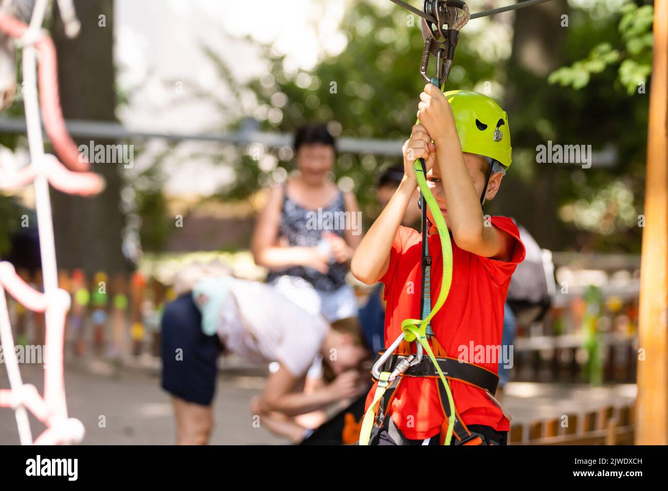 Boy climber walks on the rope bridge Stock Photo - Alamy