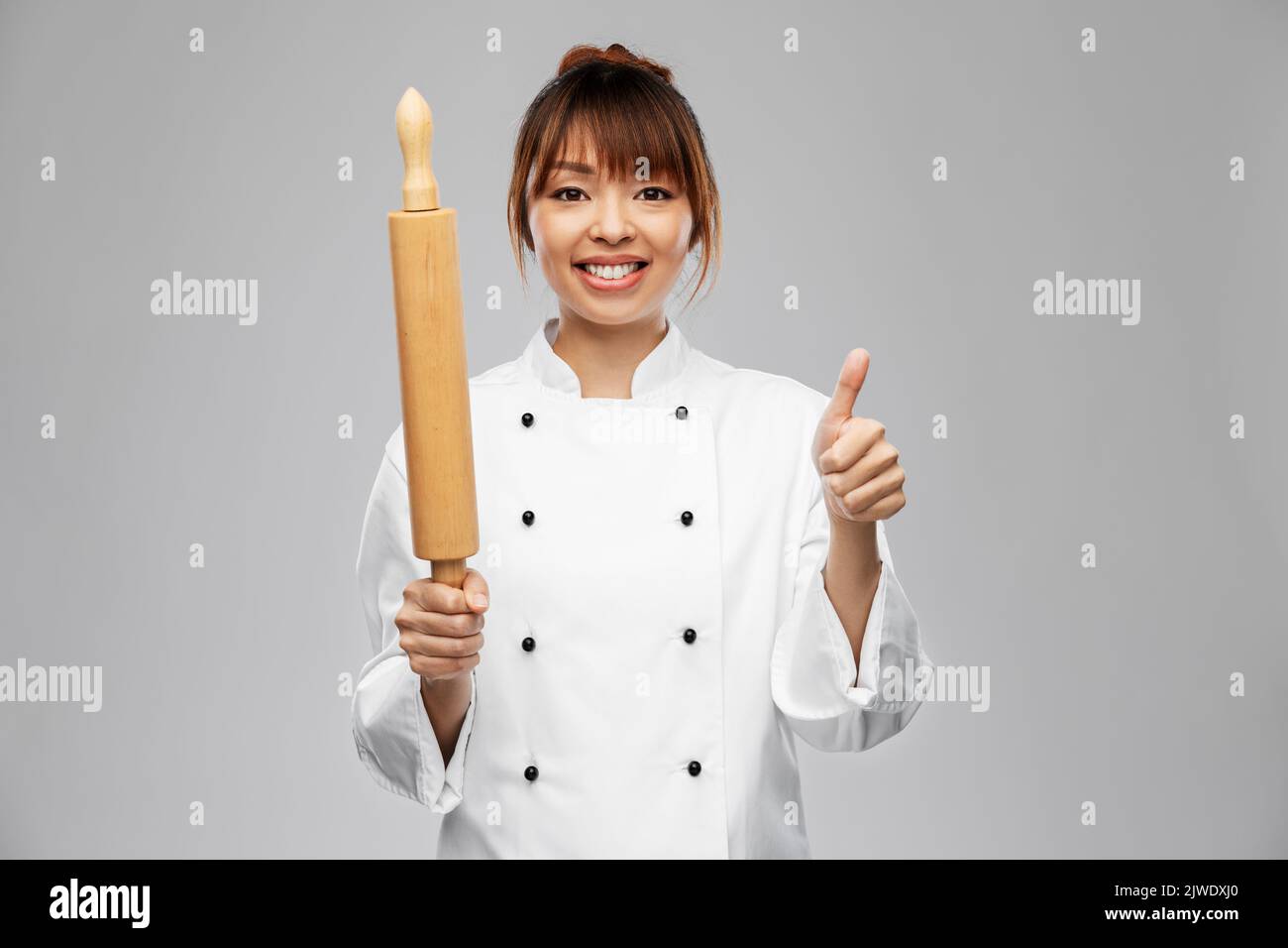 female chef with rolling pin showing thumbs up Stock Photo - Alamy