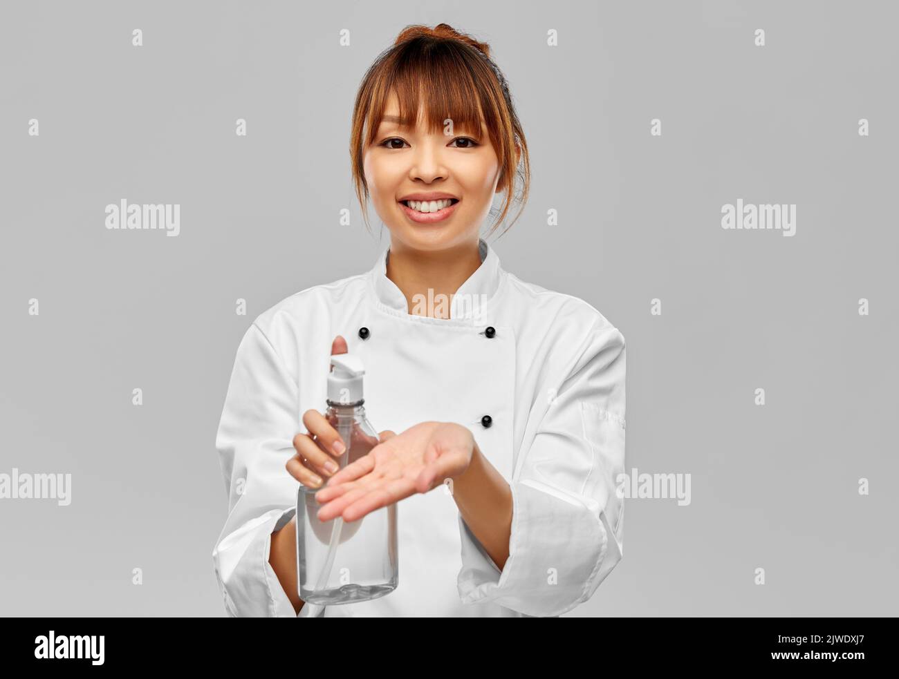 female chef applying hand sanitizer or liquid soap Stock Photo - Alamy
