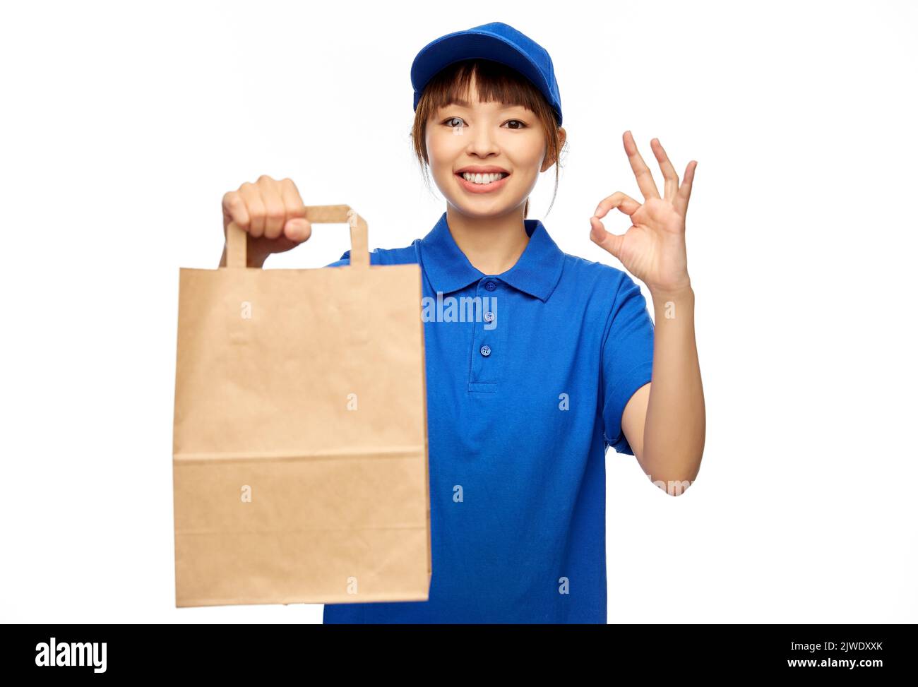delivery woman with paper bag showing ok sign Stock Photo - Alamy