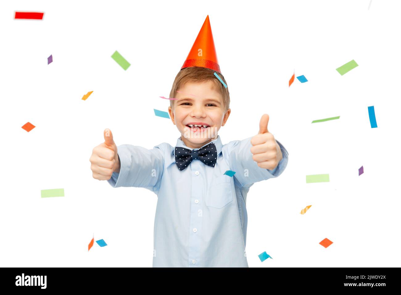 boy in birthday party hat showing thumbs up Stock Photo - Alamy