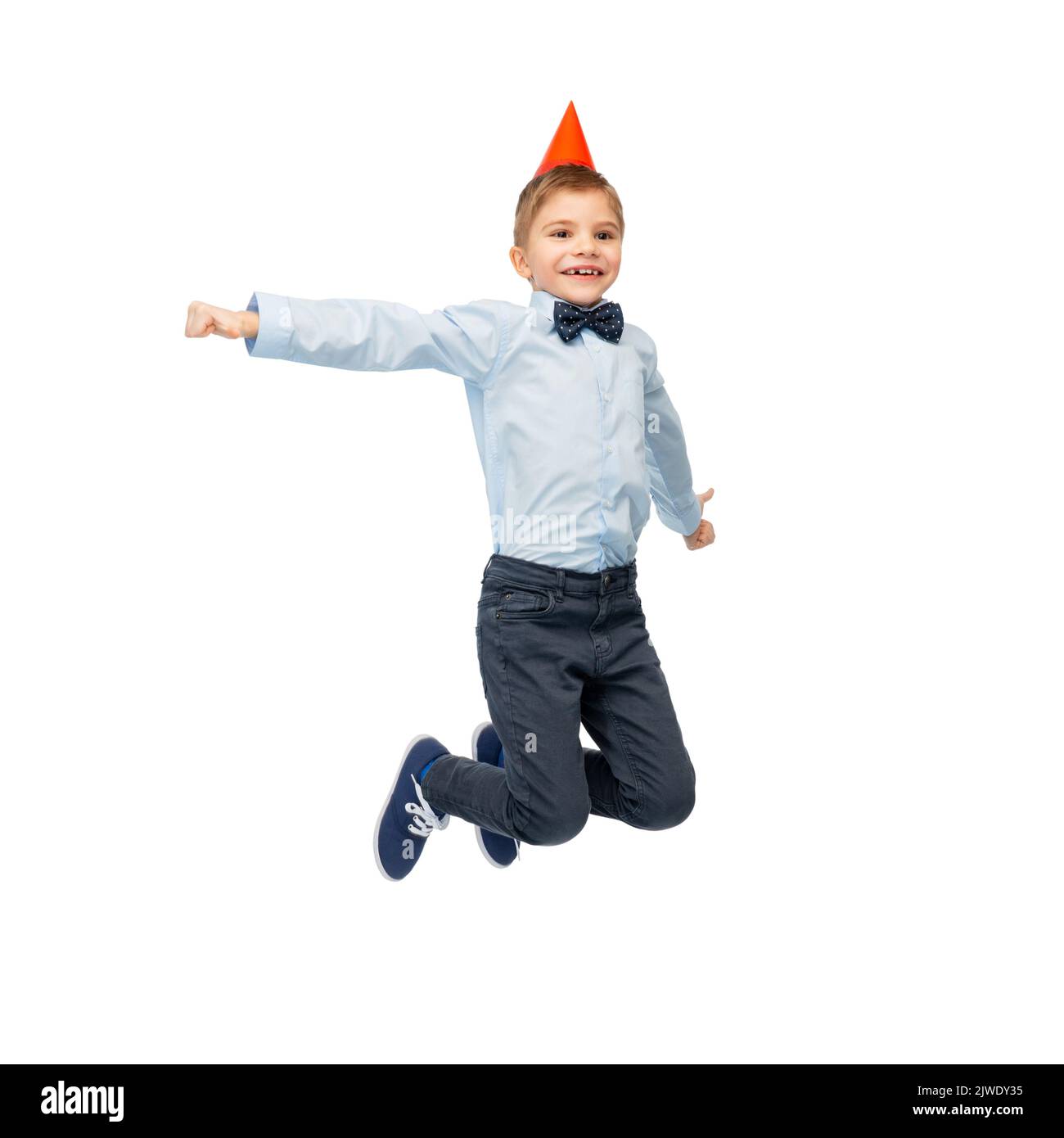 smiling little boy in birthday party hat jumping Stock Photo - Alamy