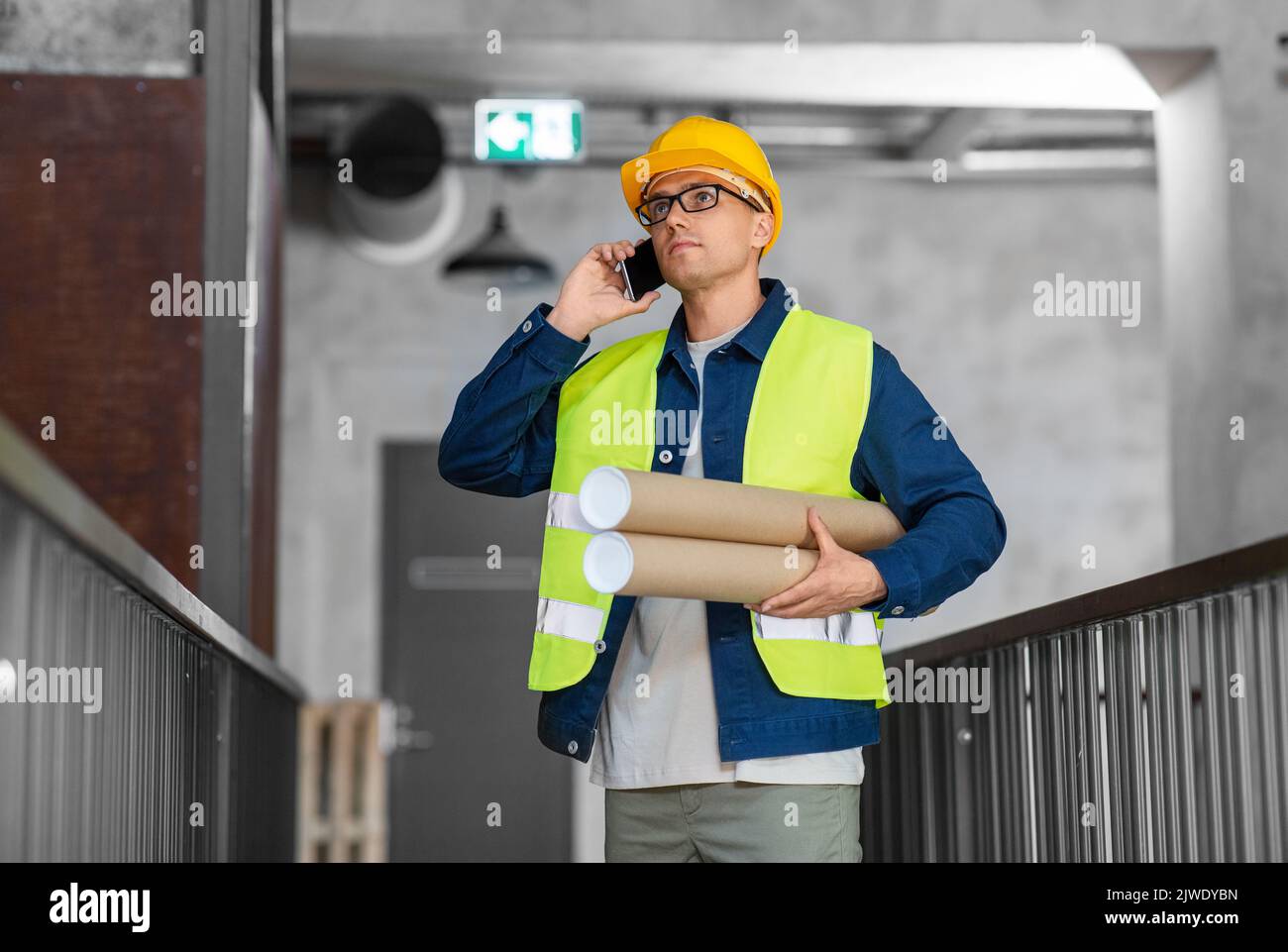 male architect with blueprint calling on phone Stock Photo - Alamy