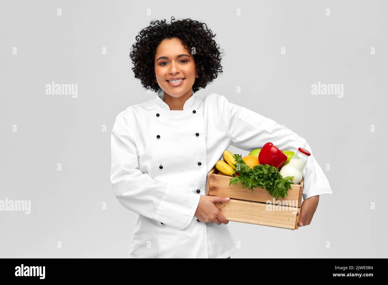 happy smiling female chef with food in wooden box Stock Photo - Alamy