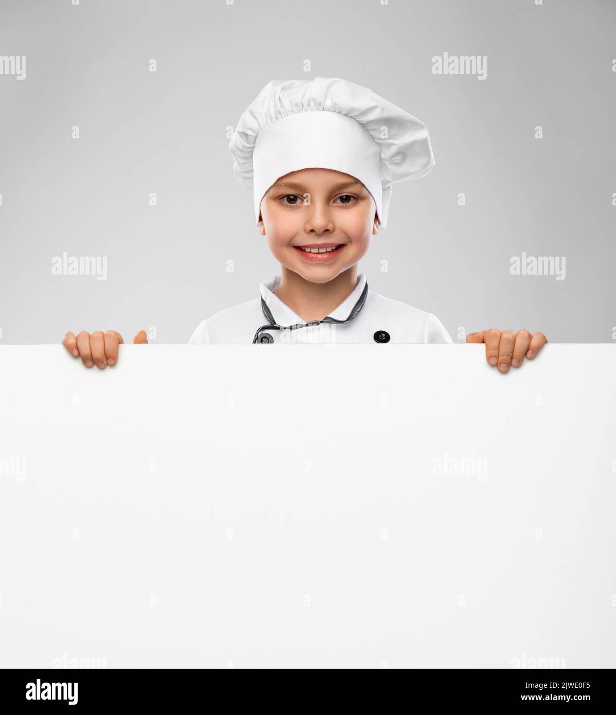 happy little boy in chef's toque with white board Stock Photo - Alamy