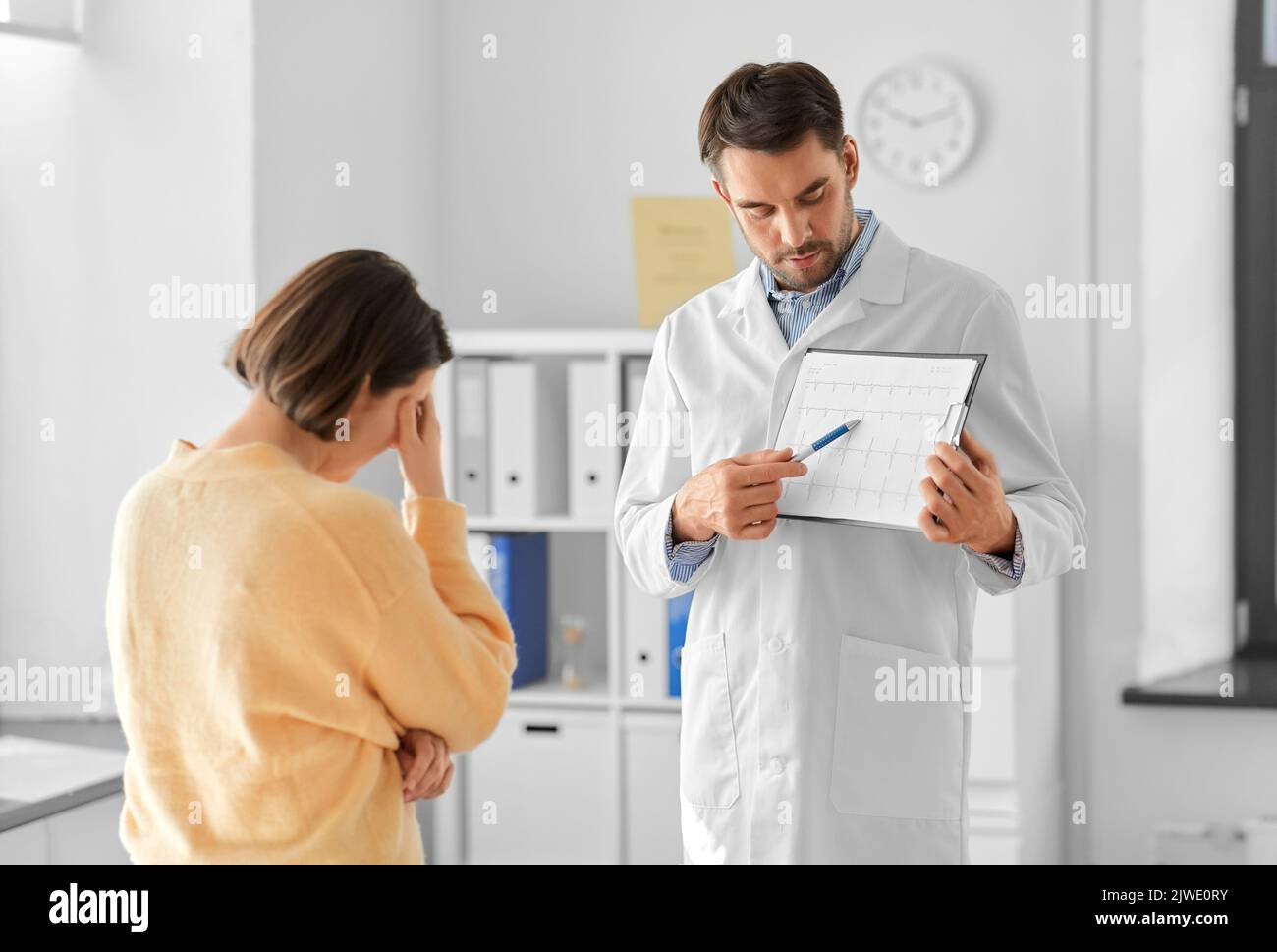 doctor showing cardiogram to sad woman at hospital Stock Photo - Alamy