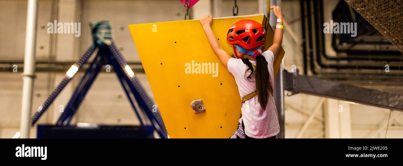 Little Girl Climbing Rock Wall Stock Photo - Alamy