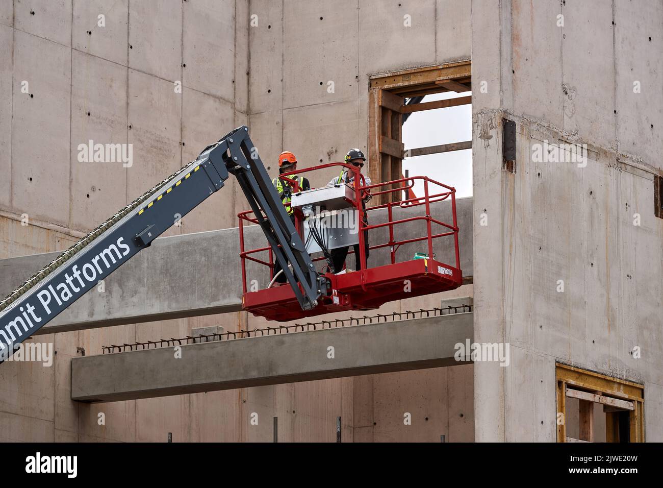Two builders in a Cherry Picker basket inspect the Anfield Road ...
