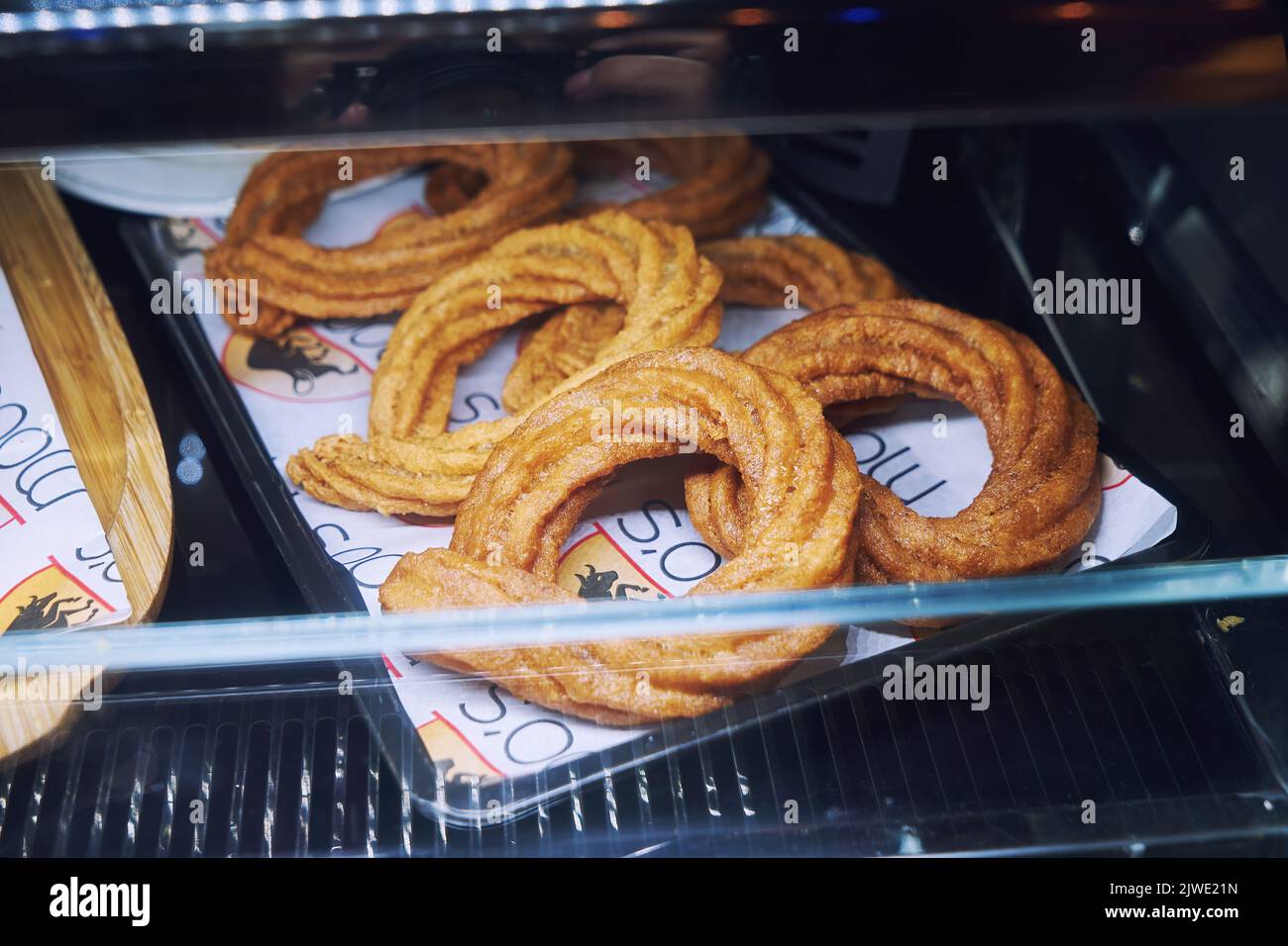 Sweet baked churros pretzel with cinnamon and caramel on counter in ...
