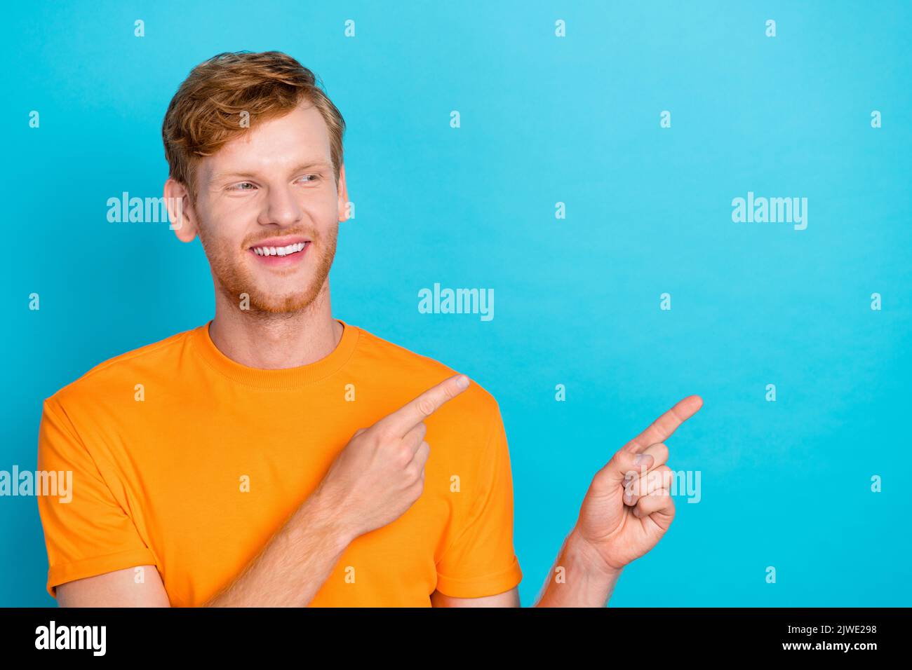 Photo of cheerful handsome positive guy red hairstyle wear yellow t ...