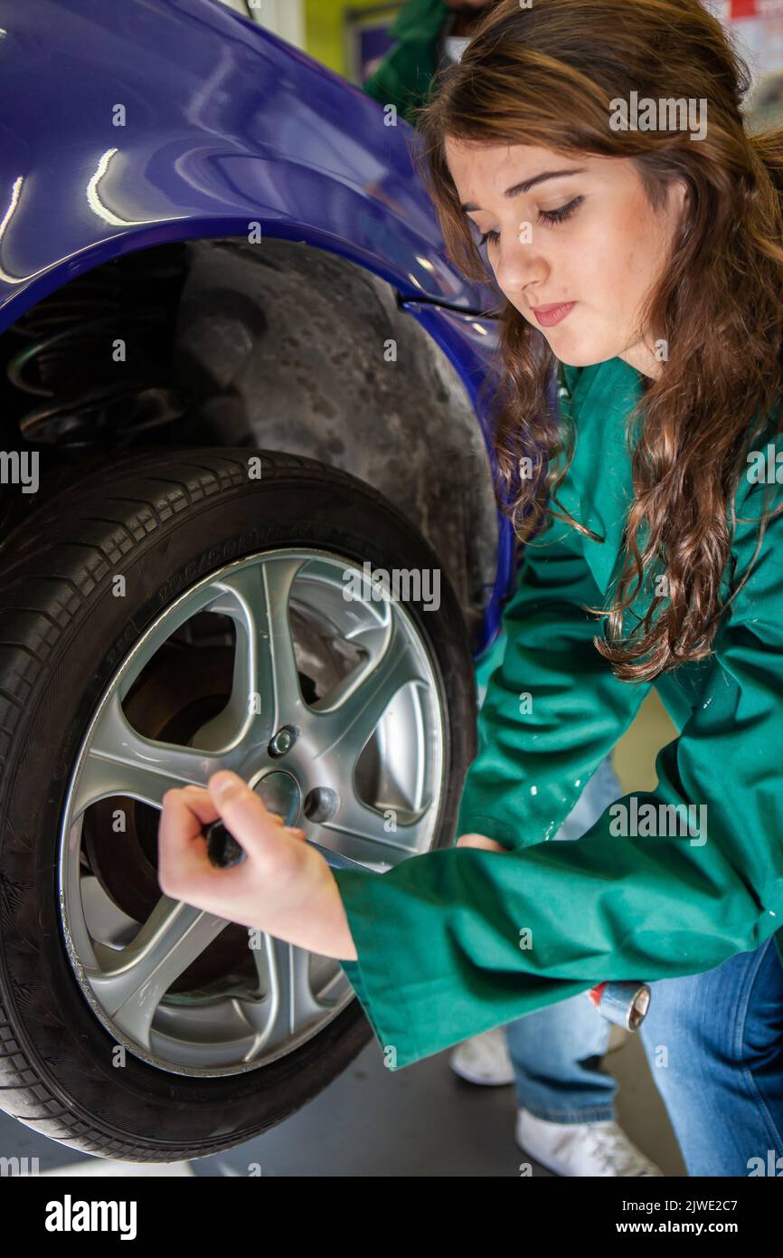 Further Education: Practical Training. A late teenage girl changing a ...