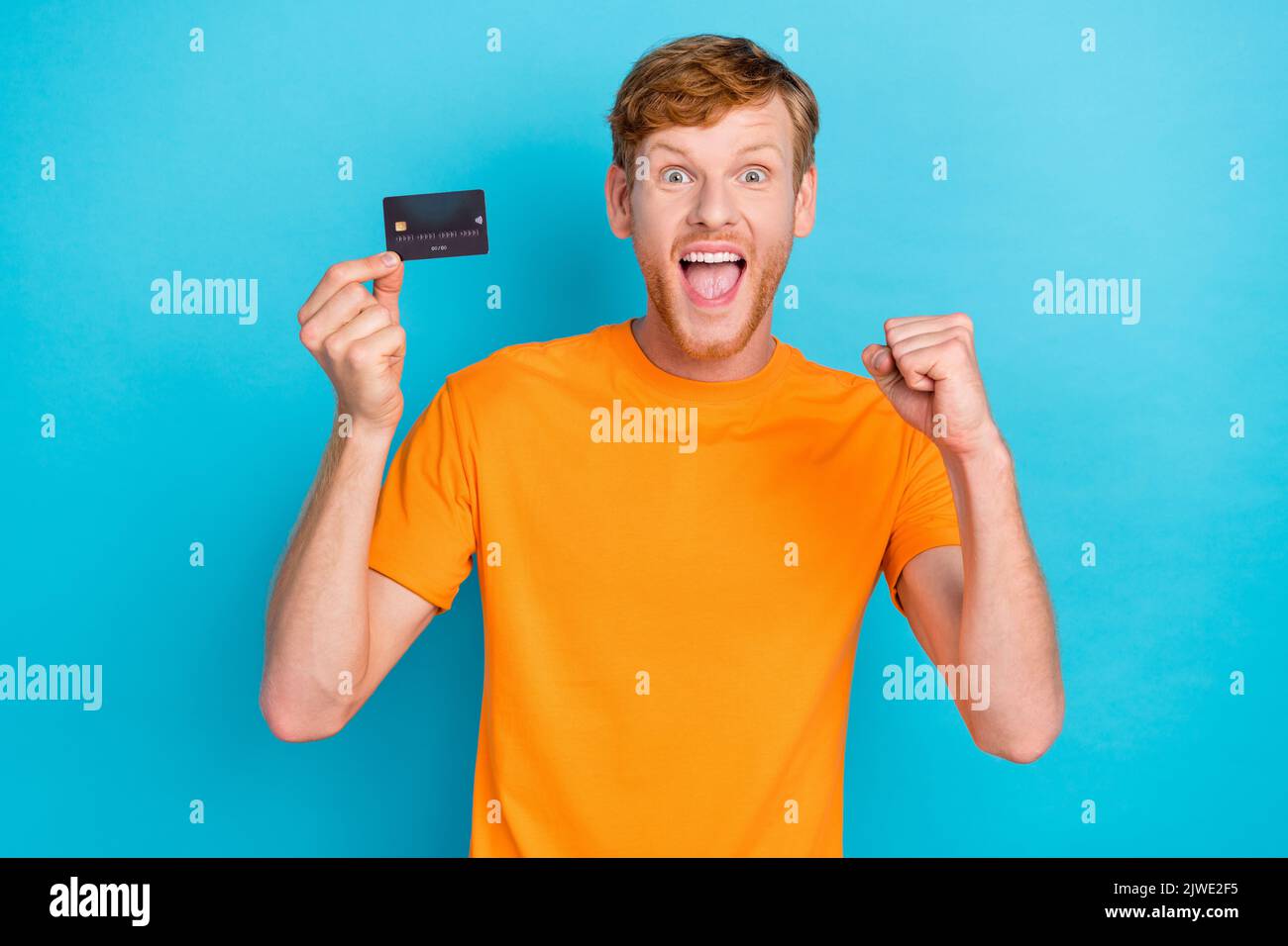 Photo of hooray ginger hair guy yell hold card wear orange t-shirt ...