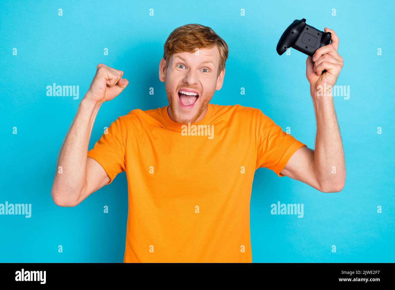 Photo of hooray red hair guy playstation yell wear orange t-shirt ...