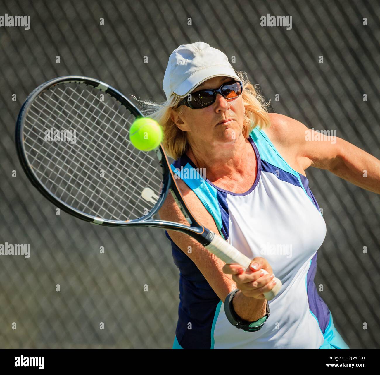 Healthy senior woman playing tennis Stock Photo - Alamy