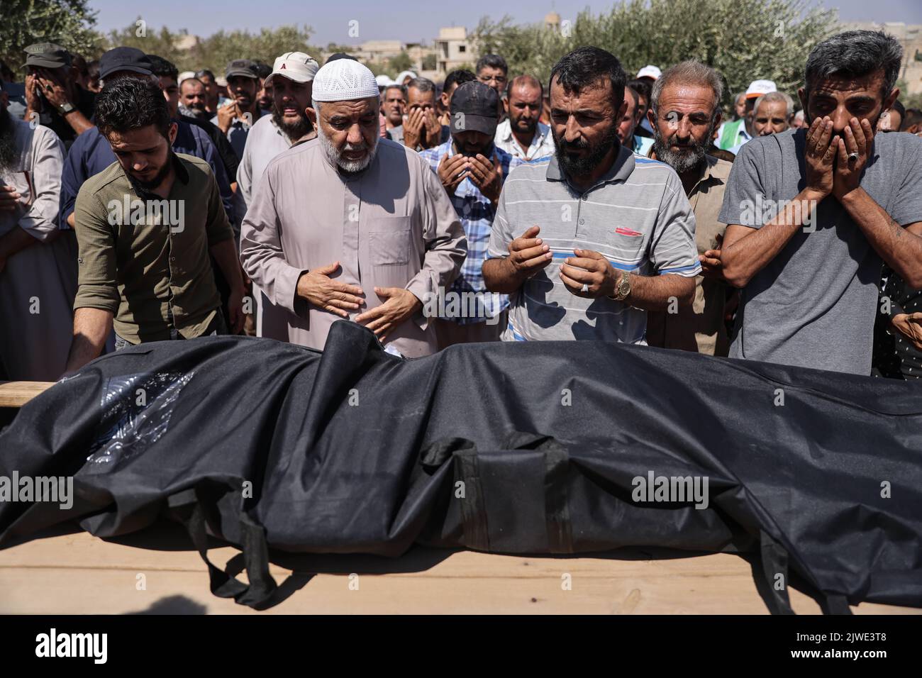 Maar Belit, Syria. 05th Sep, 2022. Syrians pray before the burial of ...