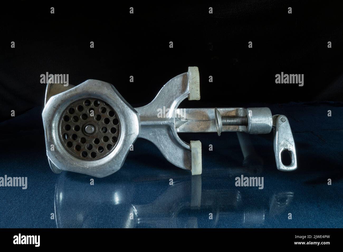 Kitchen equipment on a black background. Hand tool for meat processing ...