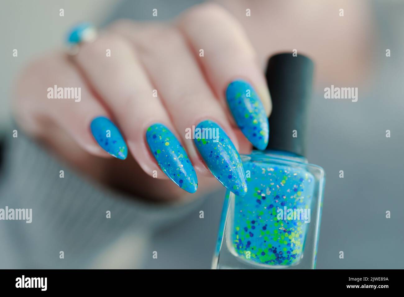 Woman's beautiful hand with long nails and light blue manicure with ...
