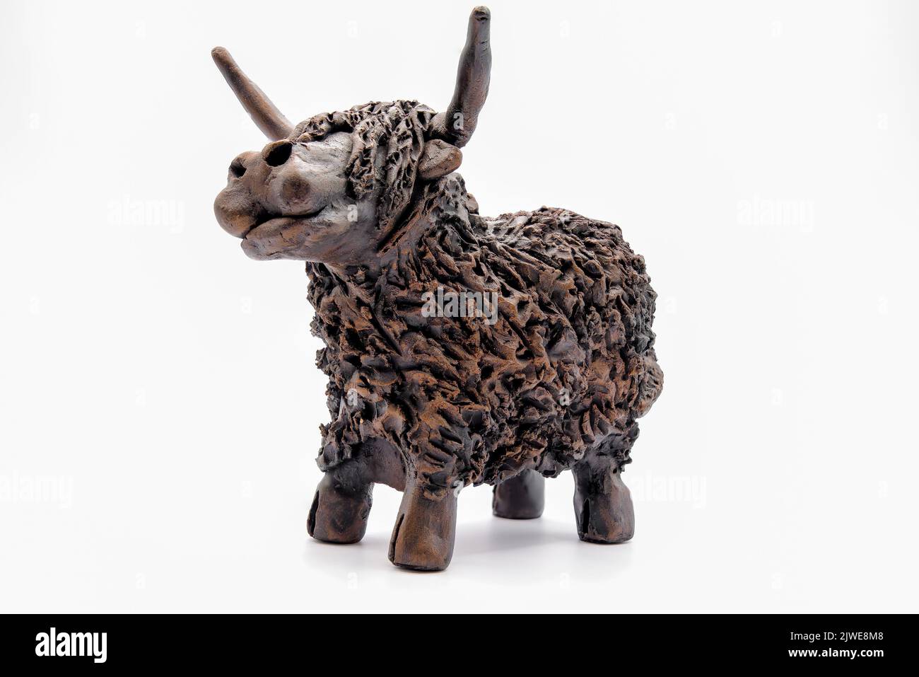 detailed close-up of a hand-made clay scottish red highland cow model ...