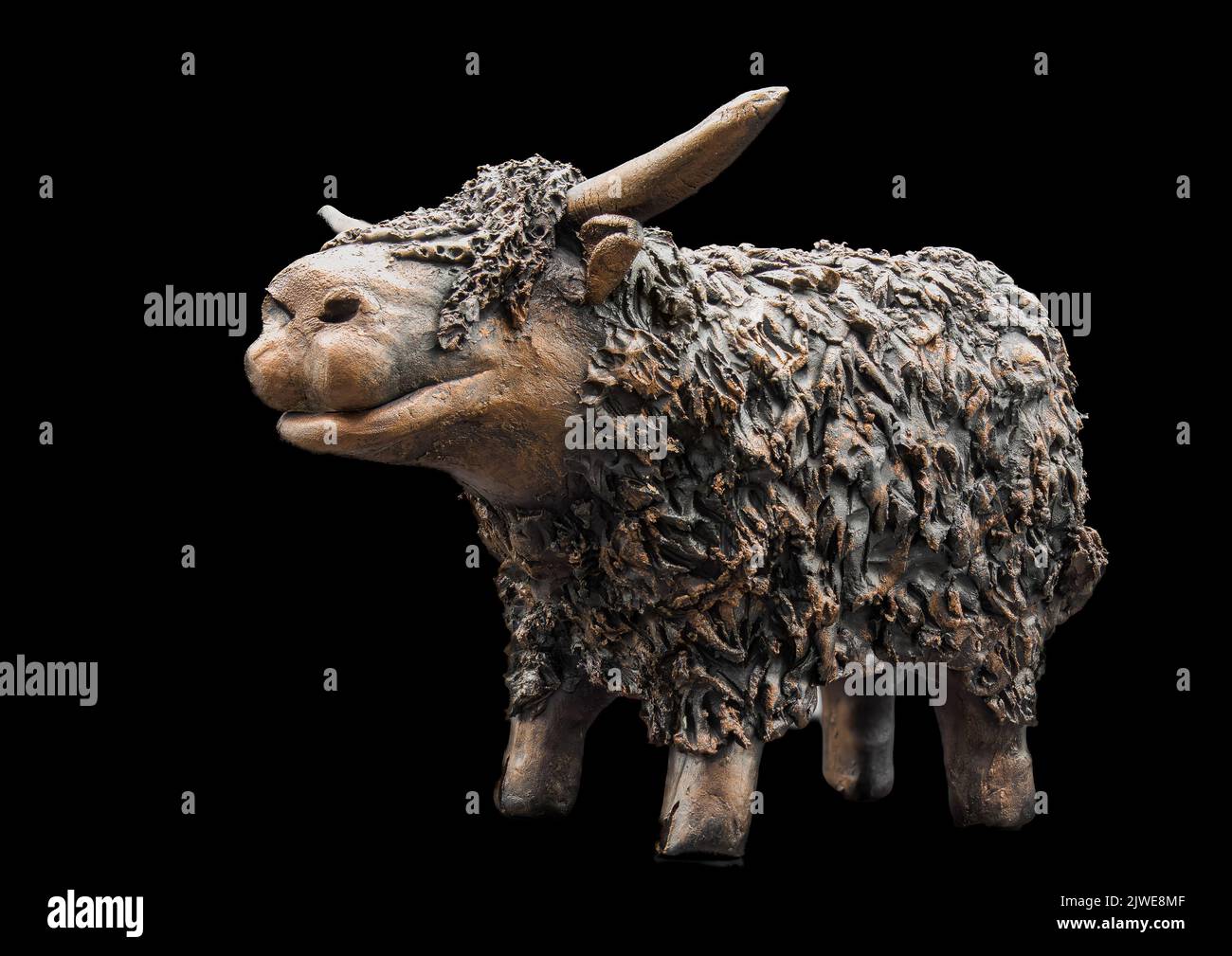 detailed close-up of a hand-made clay scottish red highland cow model ...