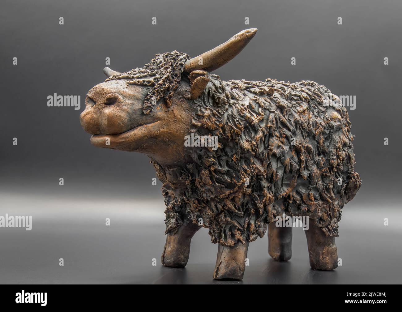 detailed close-up of a hand-made clay scottish red highland cow model ...