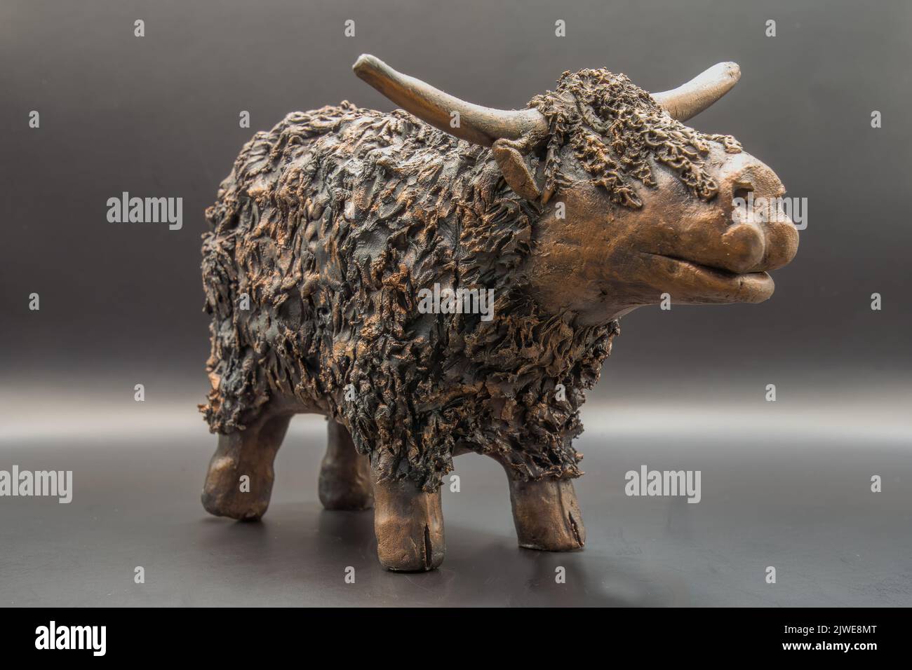 detailed close-up of a hand-made clay scottish red highland cow model ...