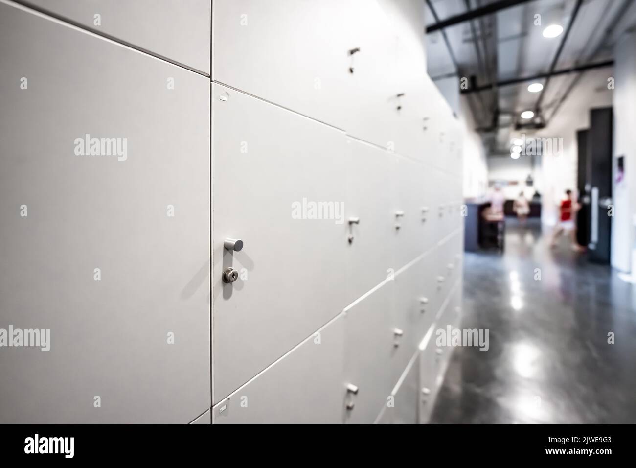 Large gray locker with each locker closed located beside corridors ...