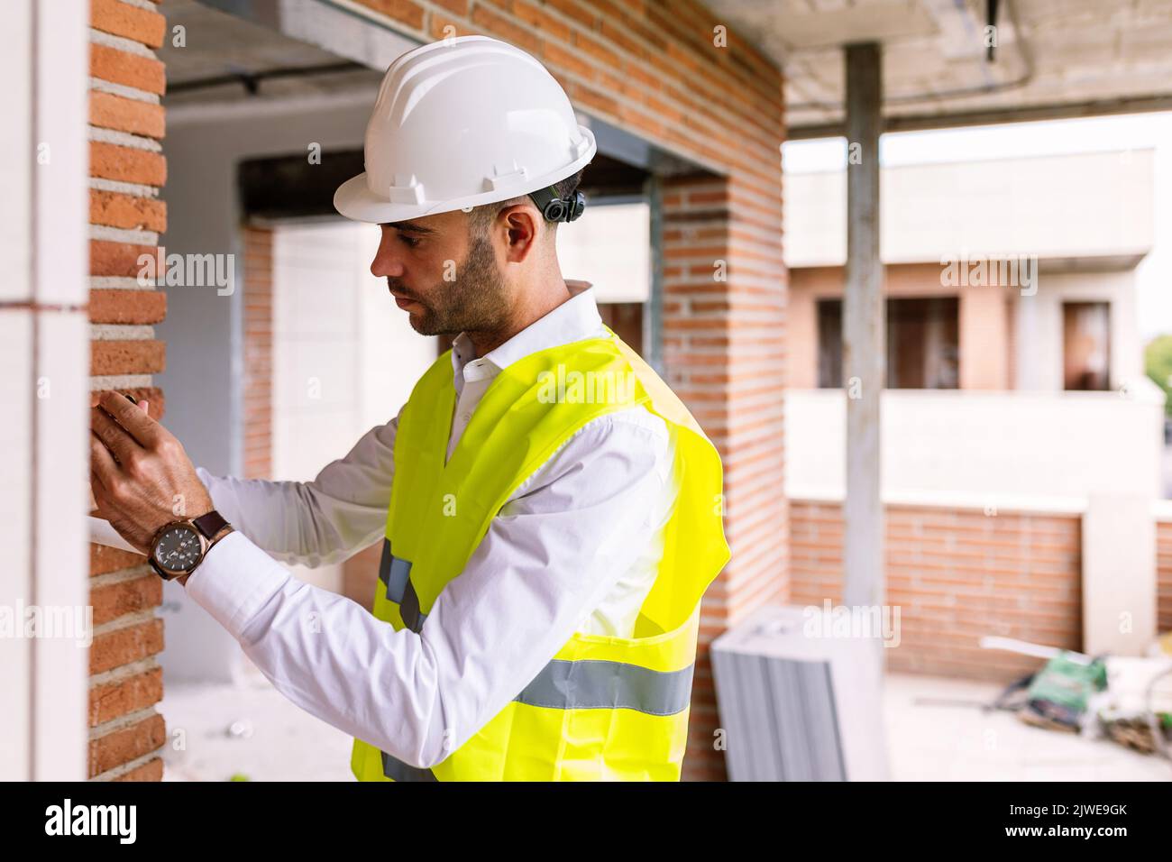 Smart civil architect engineer inspecting indoor construction building ...