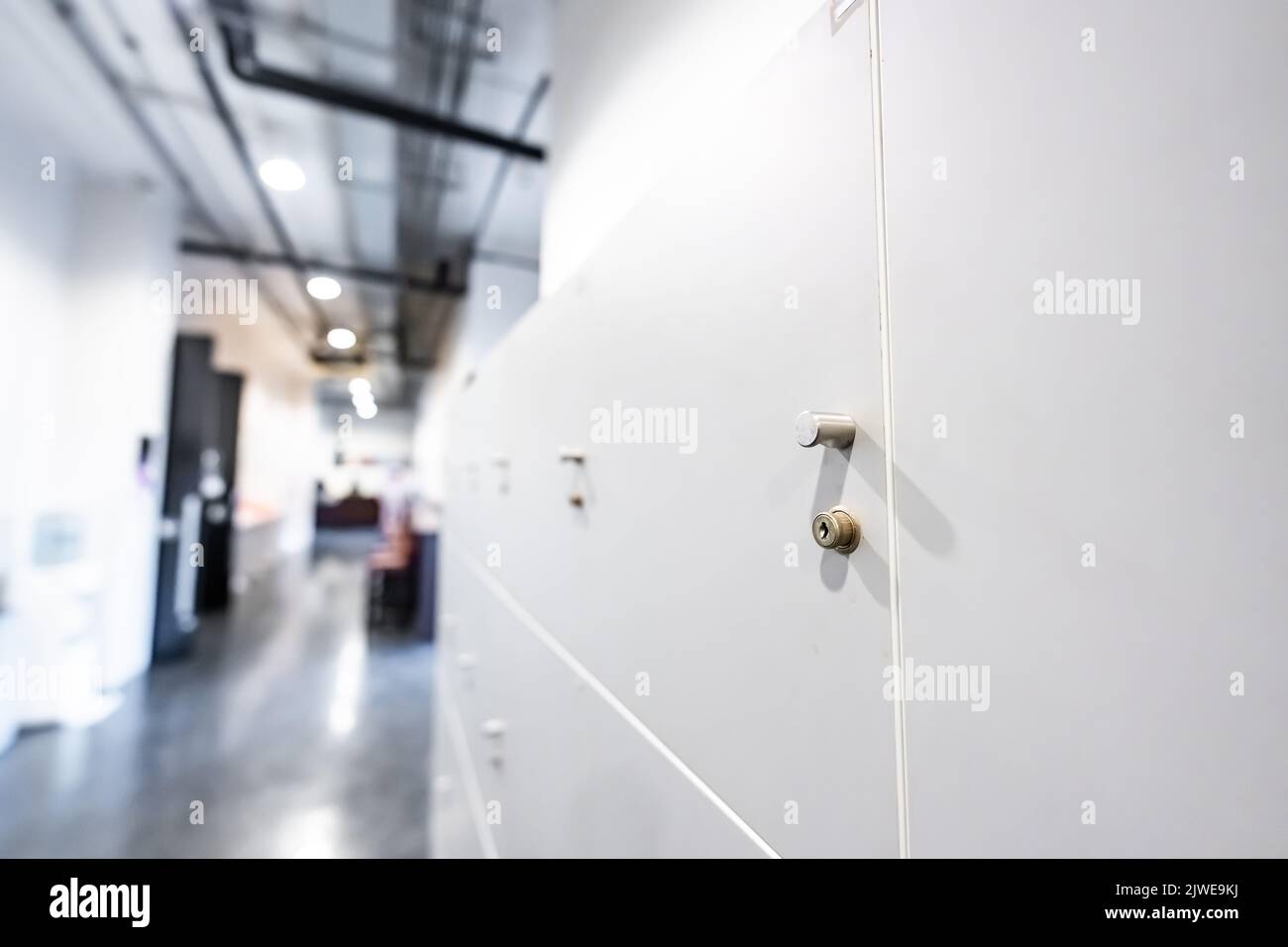 Large gray locker with each locker closed located beside corridors ...