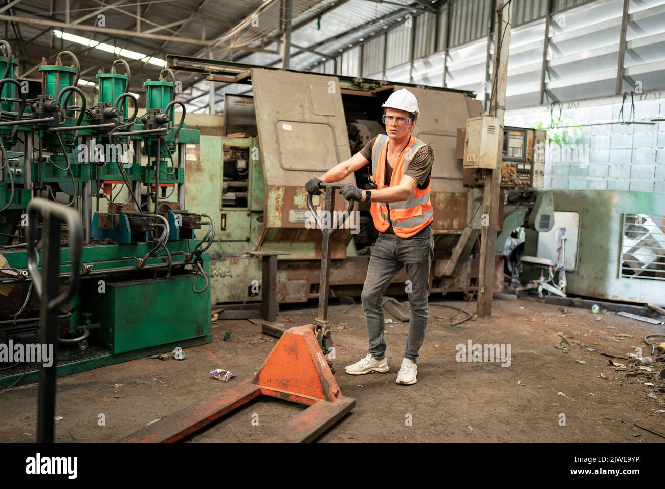 Metal industry worker dressed in work wear doing some metalwork ...