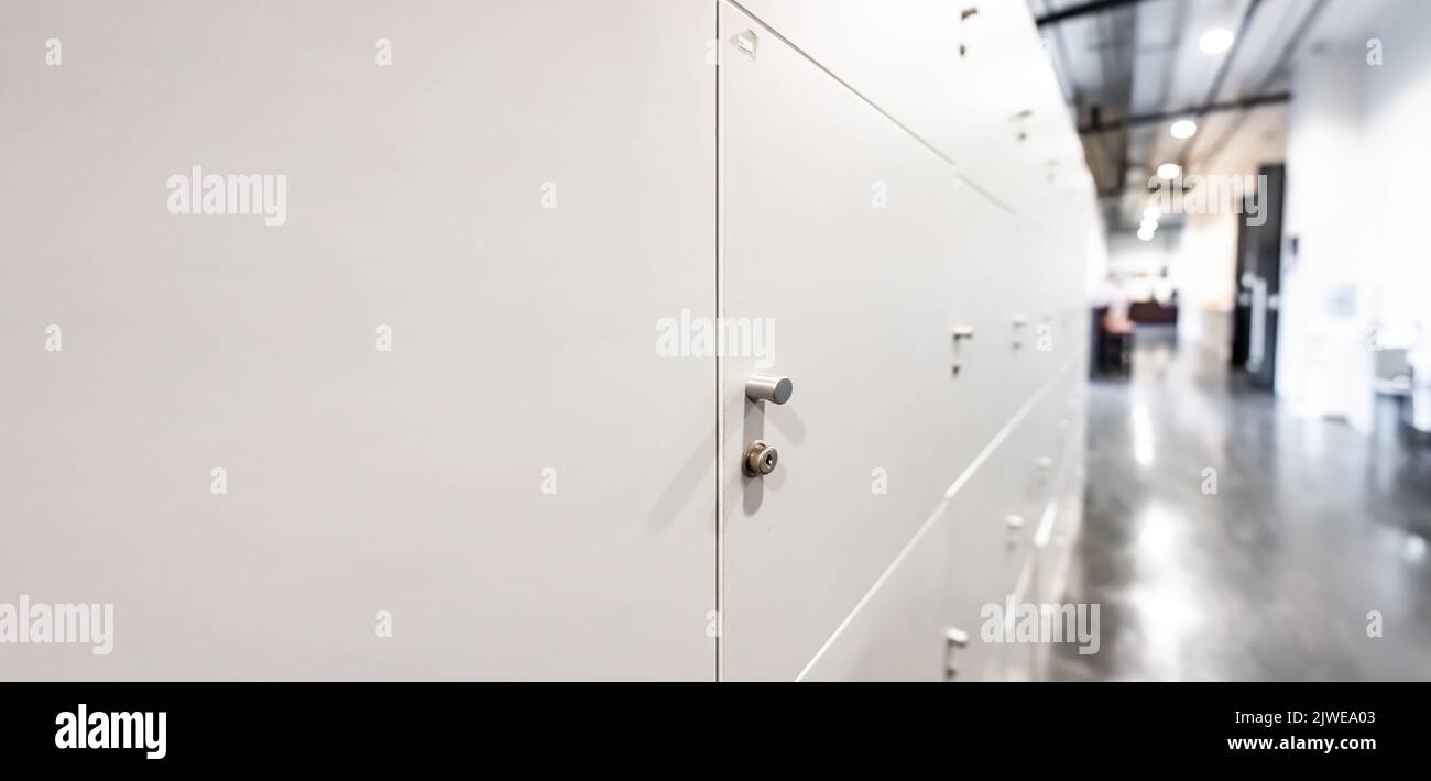 Large gray locker with each locker closed located beside corridors ...