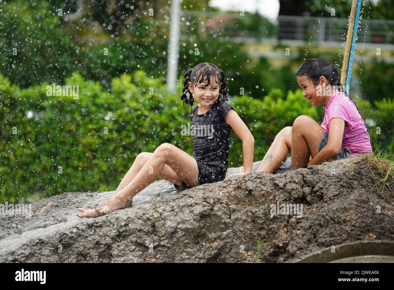 Group of kids playing on muck in the raining day Stock Photo - Alamy