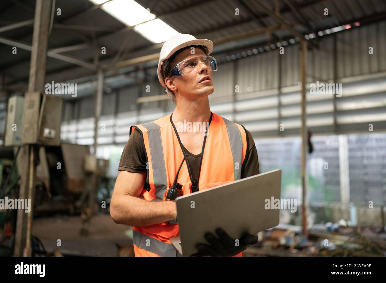 Metal industry worker dressed in work wear doing some metalwork ...