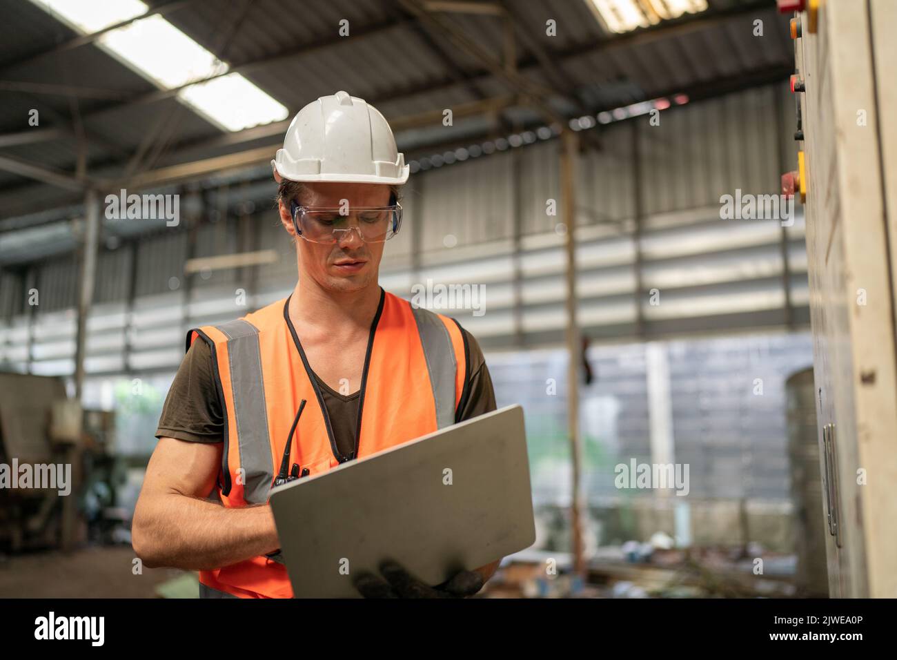 Metal industry worker dressed in work wear doing some metalwork ...