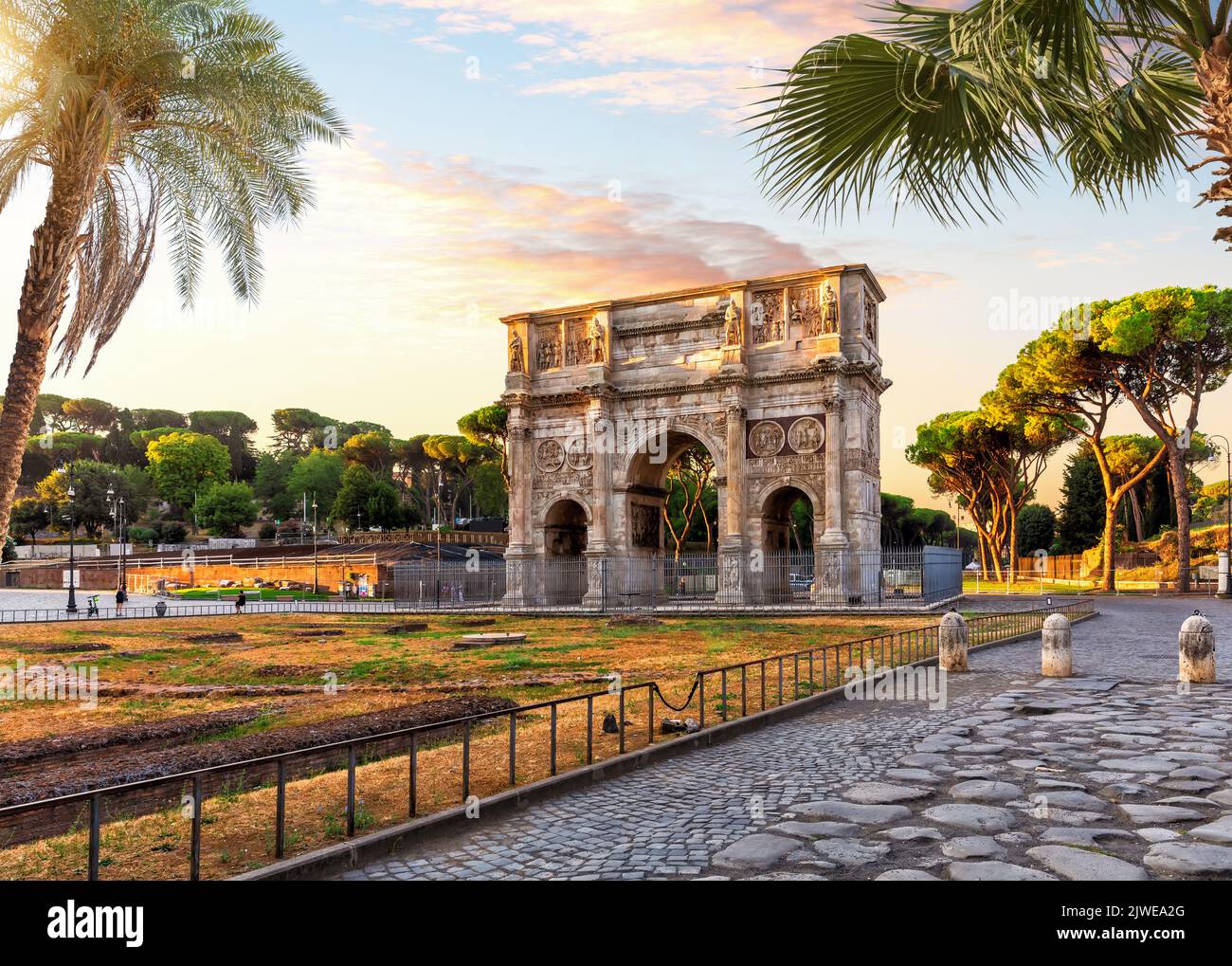 The Arch of Constantine behind the palms, famous place of visit in Rome ...