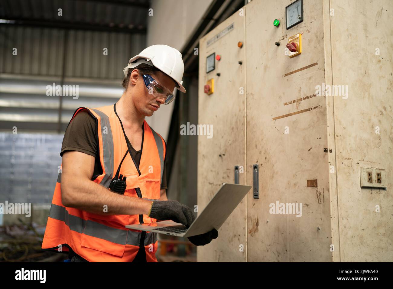 Metal industry worker dressed in work wear doing some metalwork ...