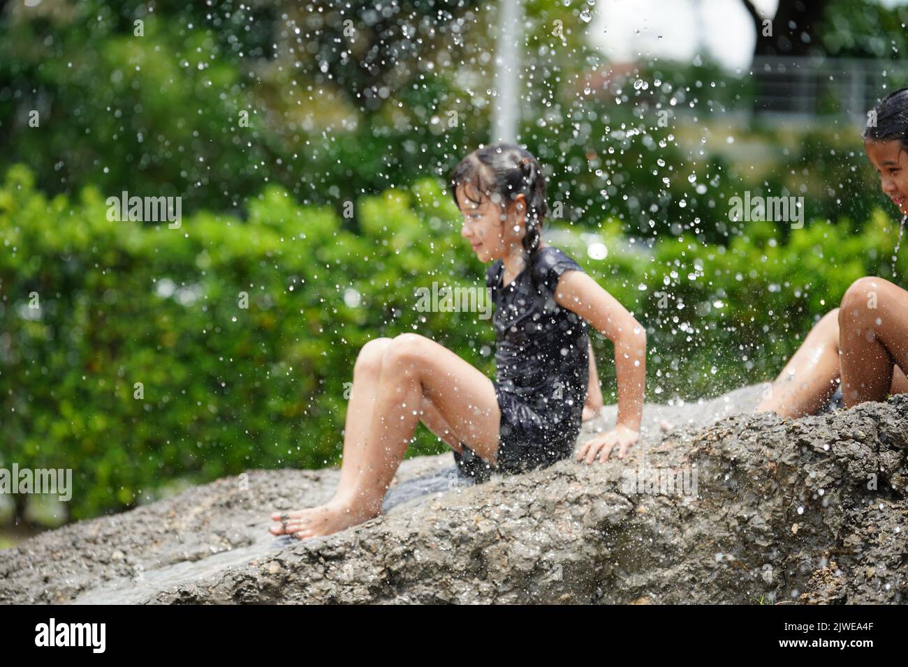 Group of kids playing on muck in the raining day Stock Photo - Alamy