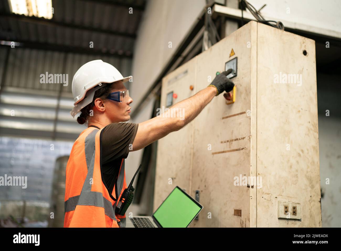 Metal industry worker dressed in work wear doing some metalwork ...