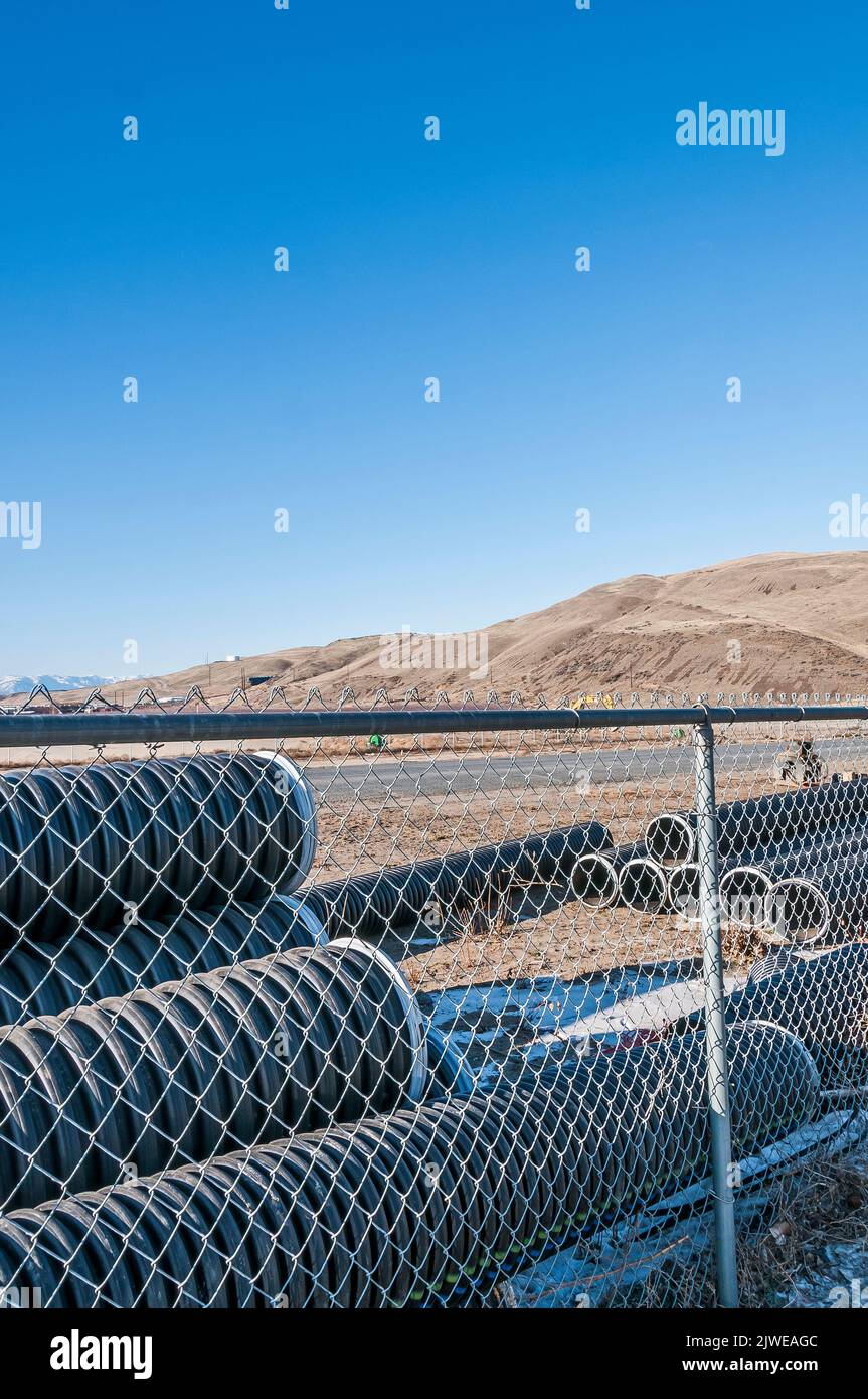 Flexible conduit or culvert pipes stacked up in an active landfill or ...