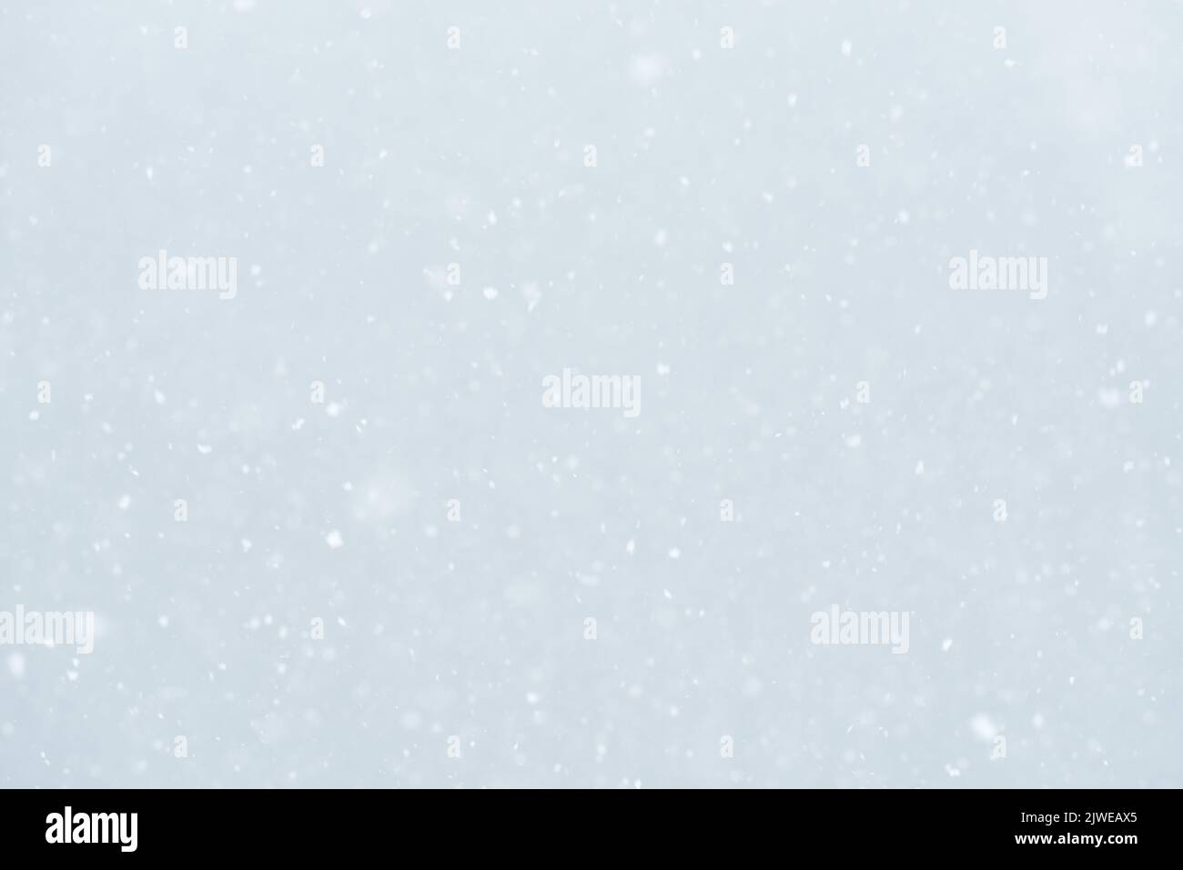 Abstract light winter background with falling snow Stock Photo - Alamy