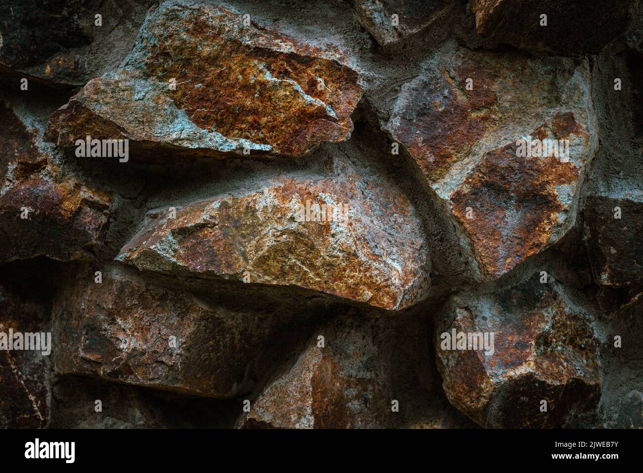 Close-up view of rough stone wall textured background Stock Photo - Alamy