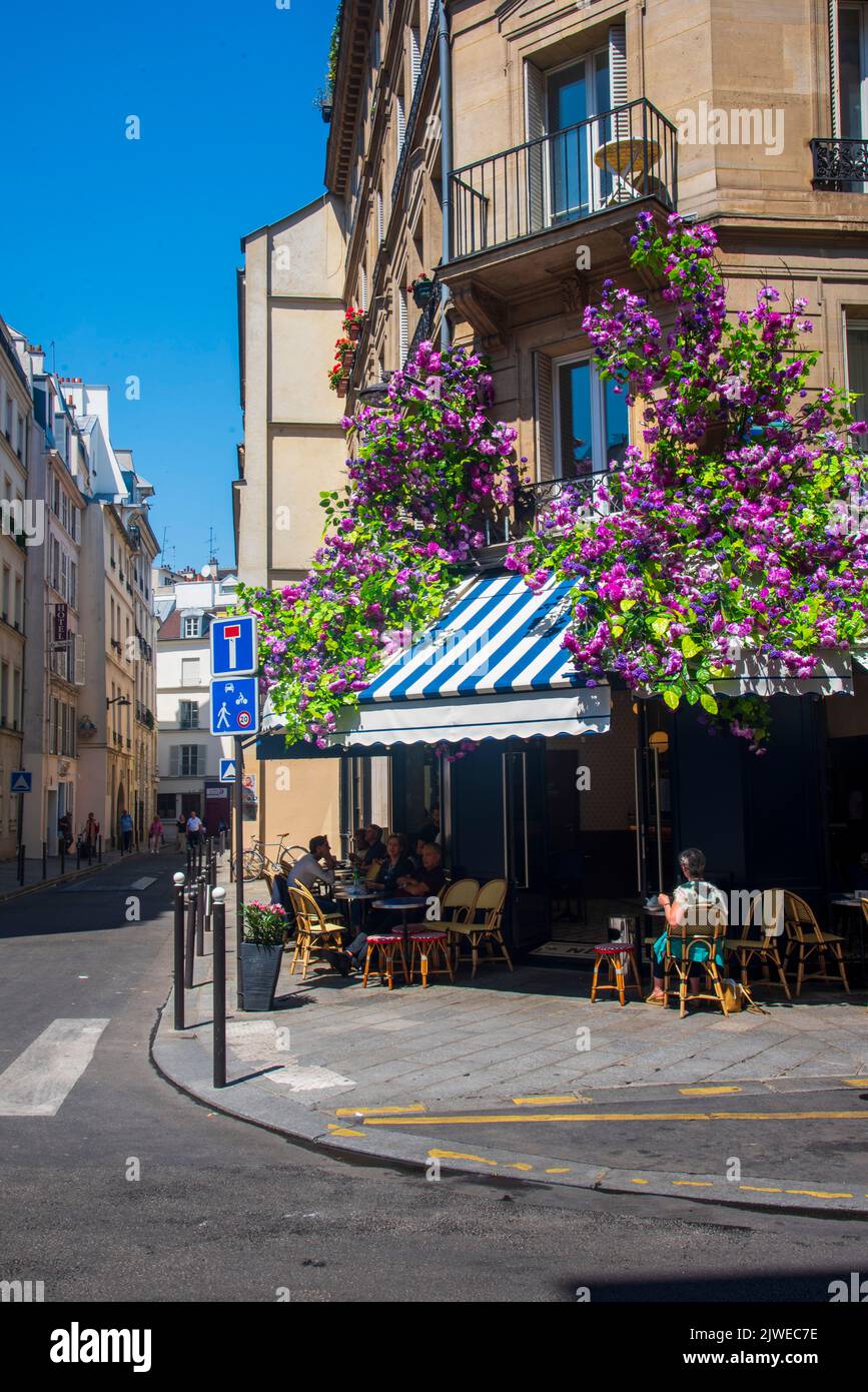 Parisian Cafe on the corner with awning and flowers Stock Photo - Alamy