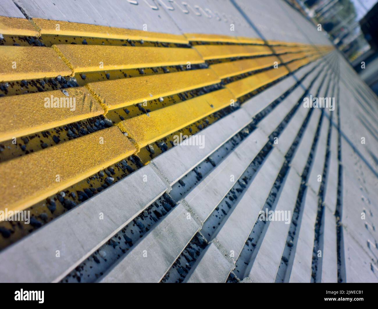 Pavement detail in a railway station with yellow line Stock Photo - Alamy