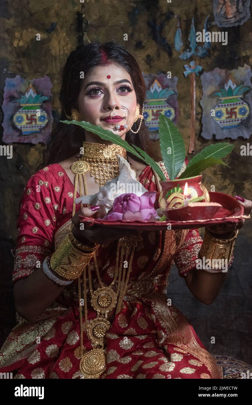 Concept Agomoni shoot , Indian Women holding a Boron Dala..It is ...